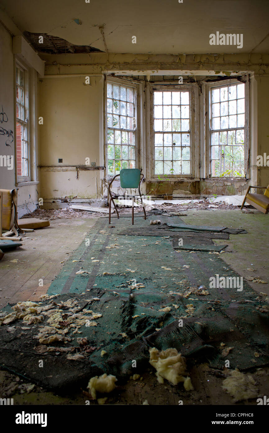 chair by a large window in an abandoned asylum Stock Photo - Alamy
