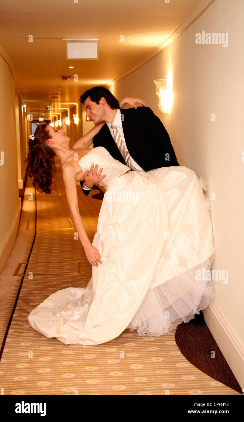 Groom carrying bride into hotel room Stock Photo - Alamy