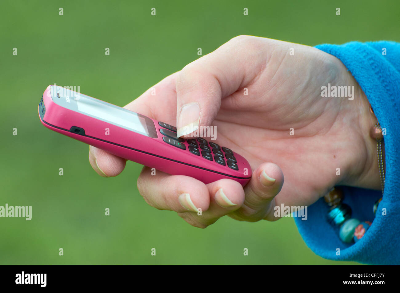 Woman's hand texting on an old style mobile phone Stock Photo - Alamy