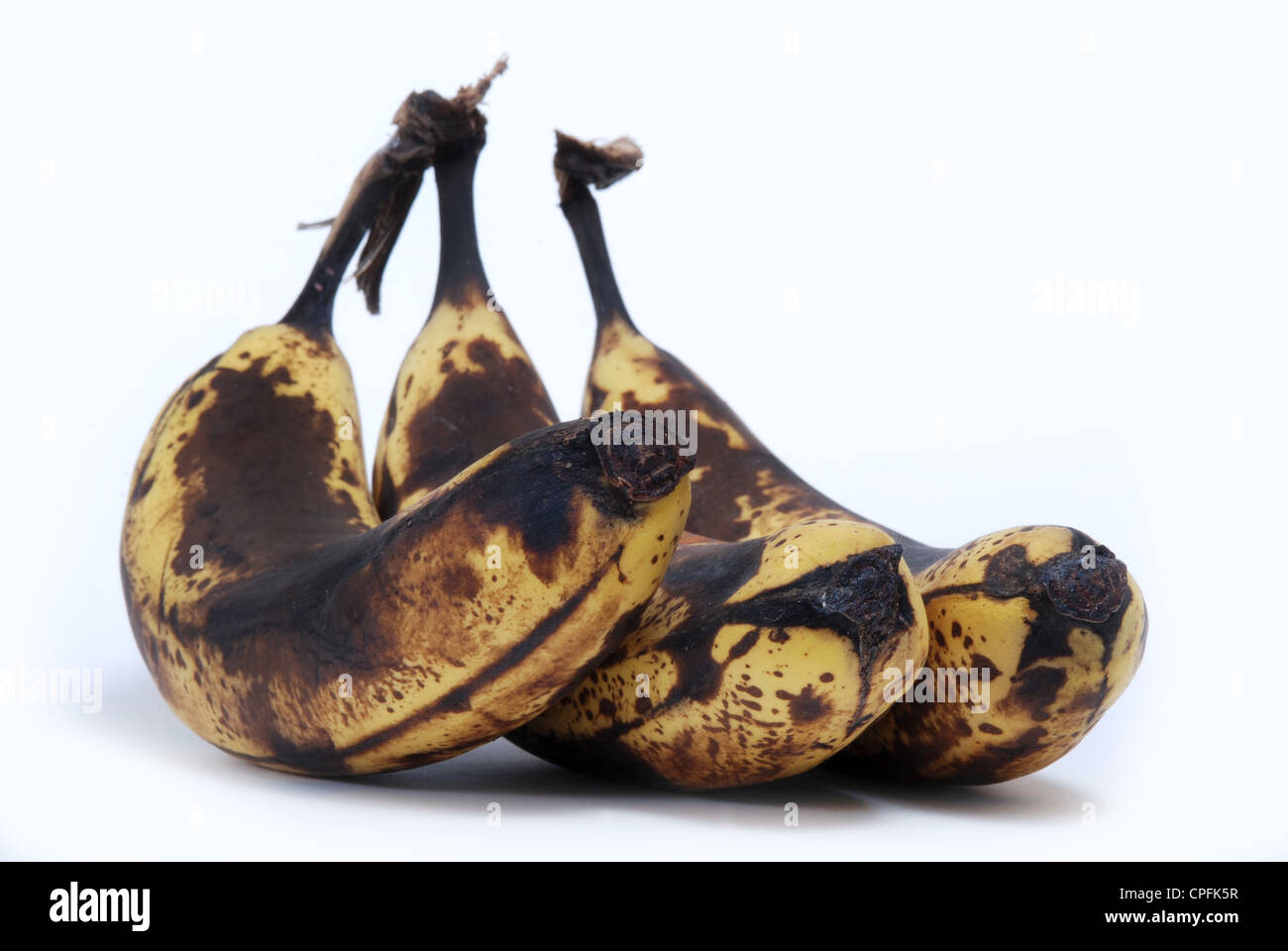 Three over ripe bananas, isolated on white Stock Photo - Alamy
