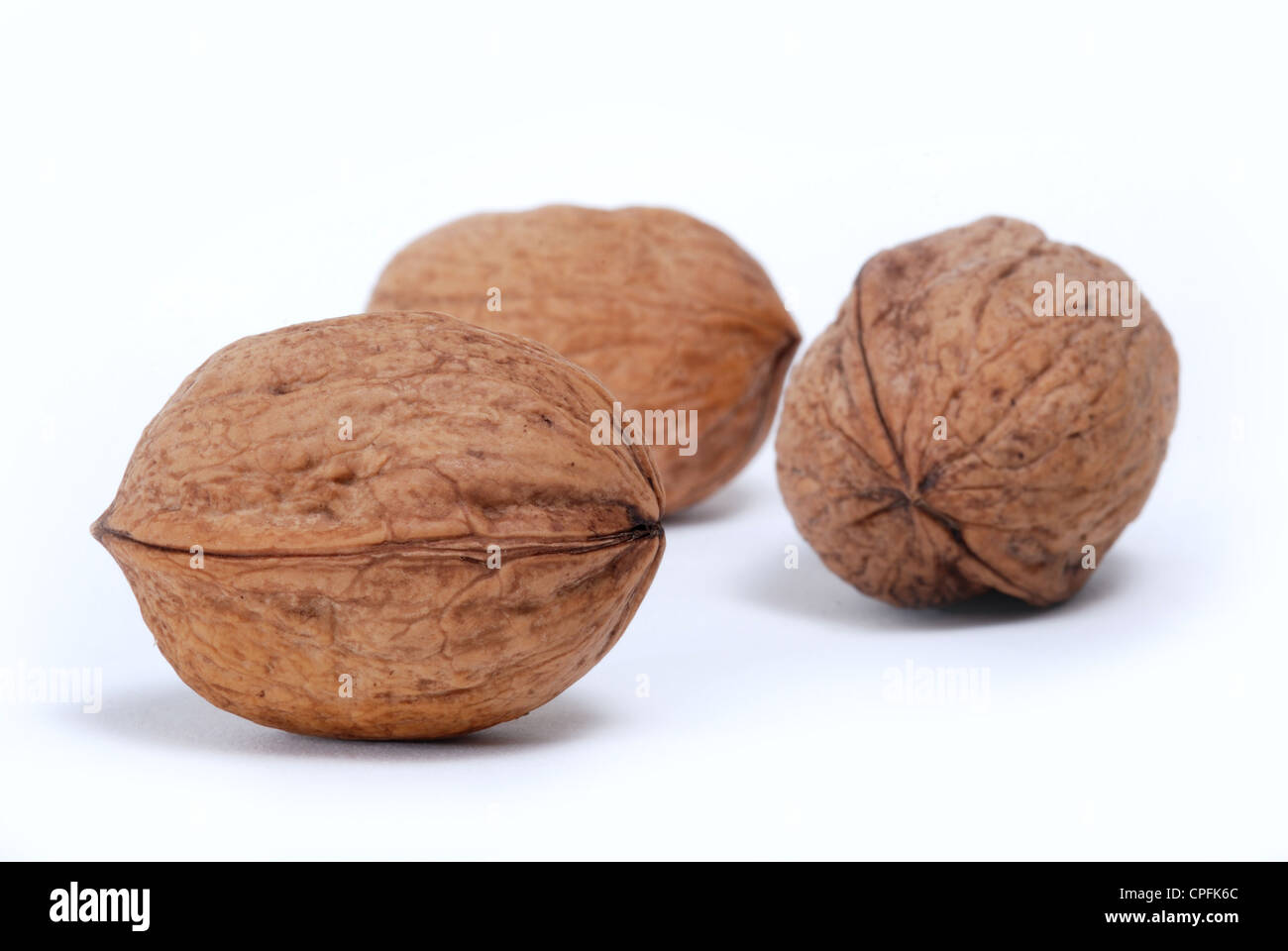 Close up of three walnuts, whole. Isolated on white Stock Photo - Alamy