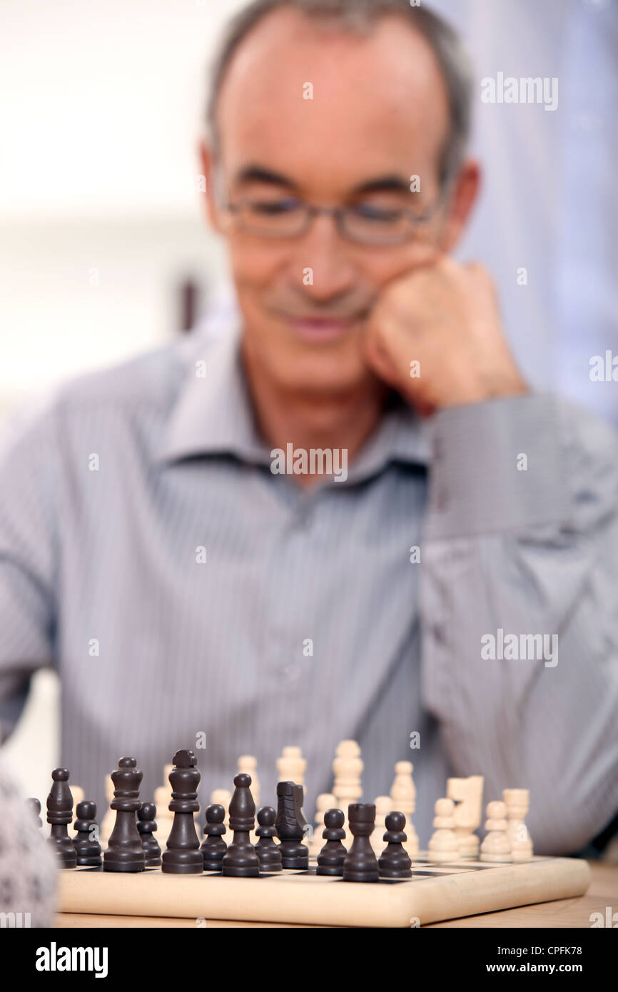 Old man playing chess Stock Photo - Alamy