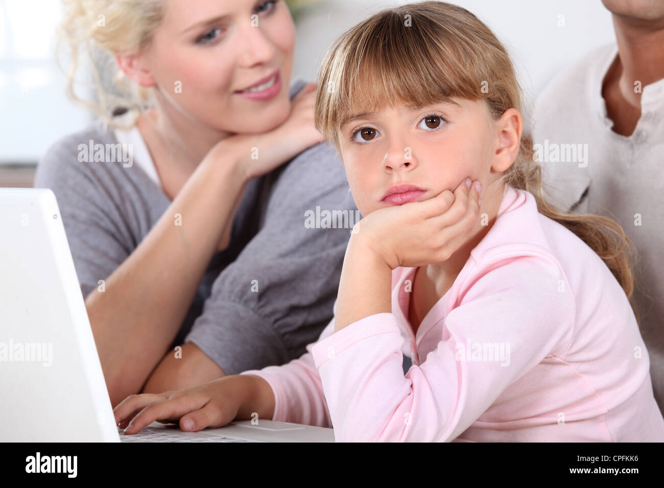 Parents with daughter and computer Stock Photo - Alamy