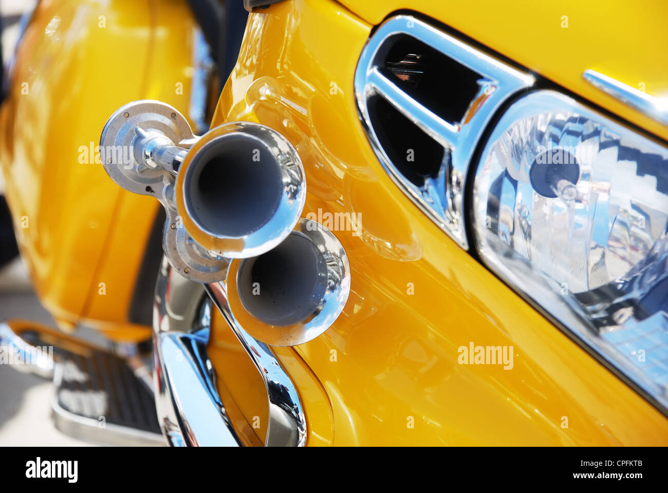 part of yellow motorcycle with headlight and pipe Stock Photo - Alamy