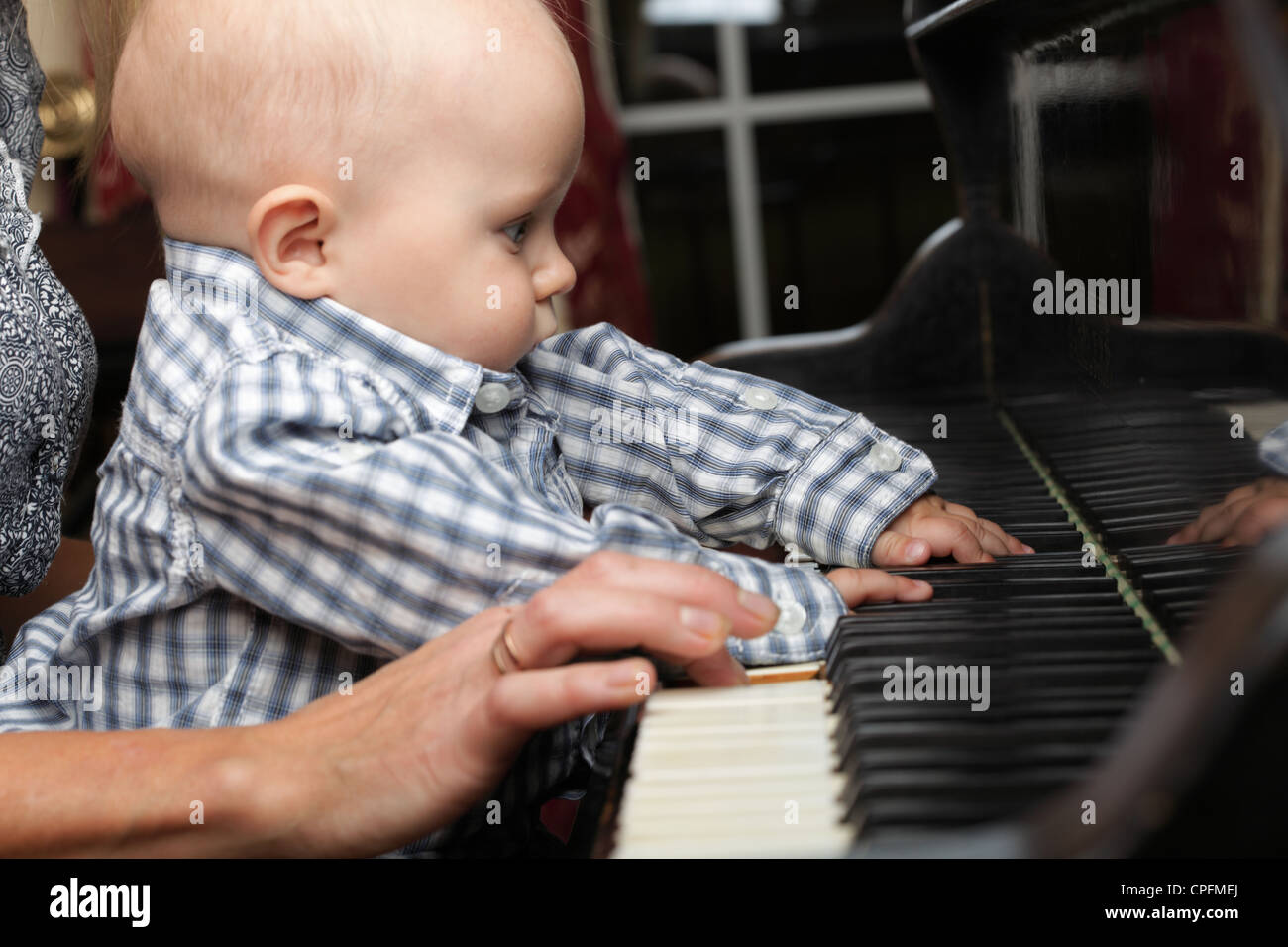 beautiful little baby boy learning plays piano, education Stock Photo ...