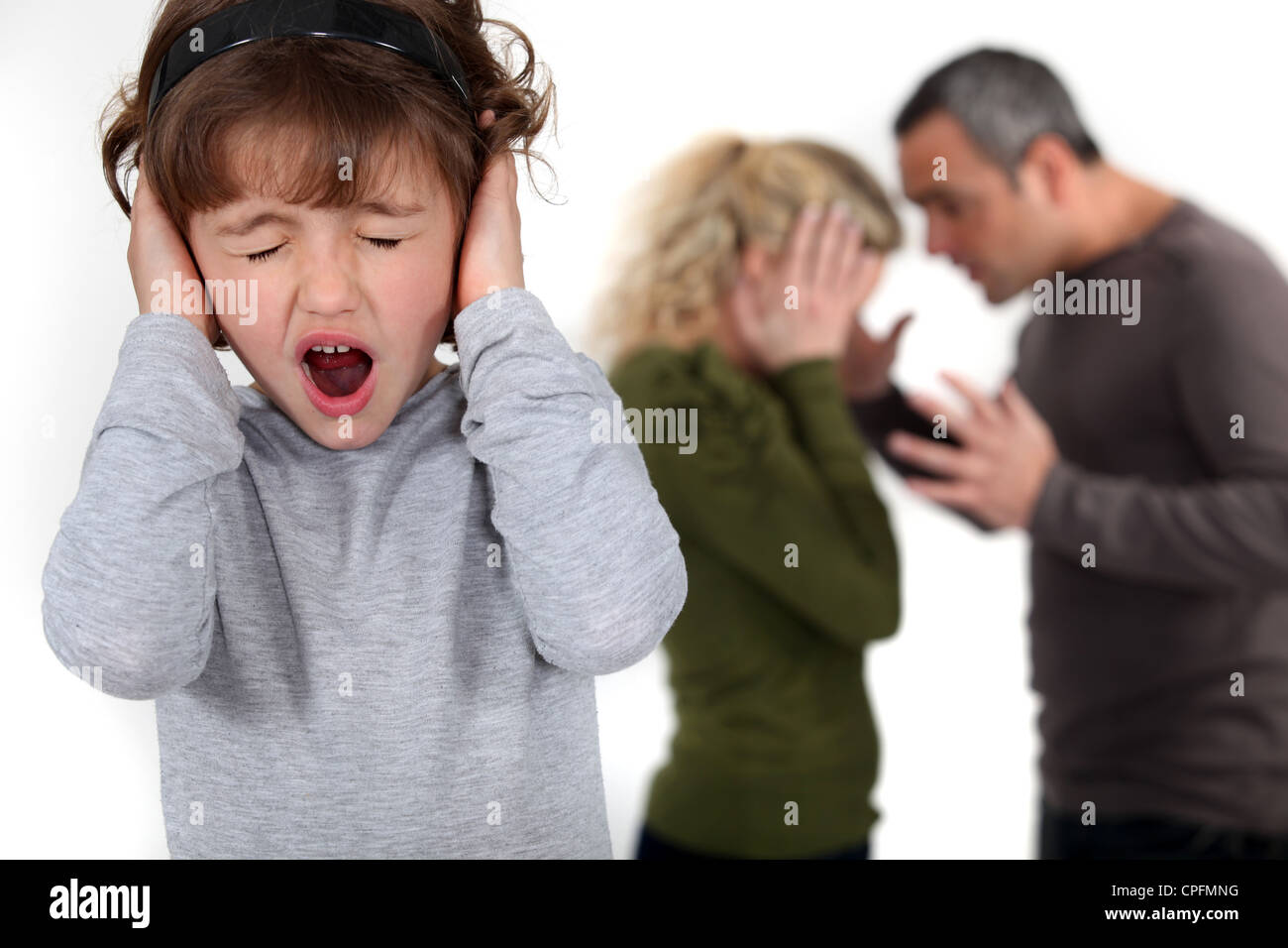 Young child trying to block out her parents' argument Stock Photo - Alamy