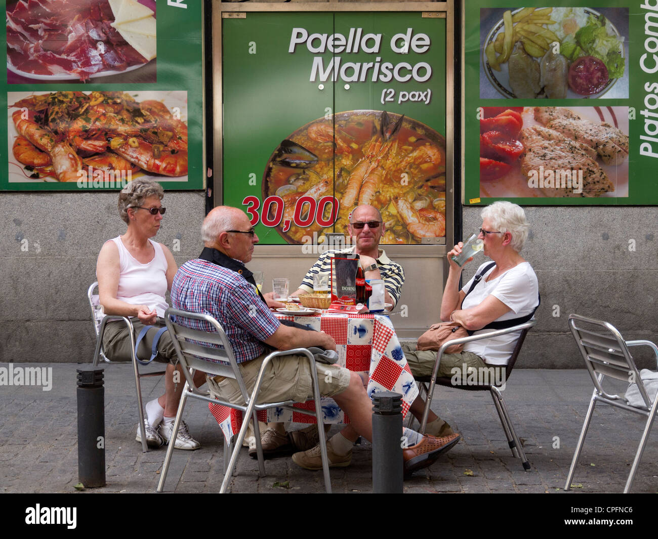 People eating paella at an outdoor restaurant in Madrid, Spain, Europe ...