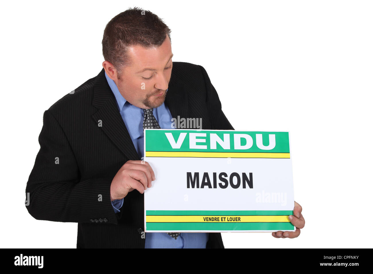 Estate agent holding sold sign Stock Photo - Alamy