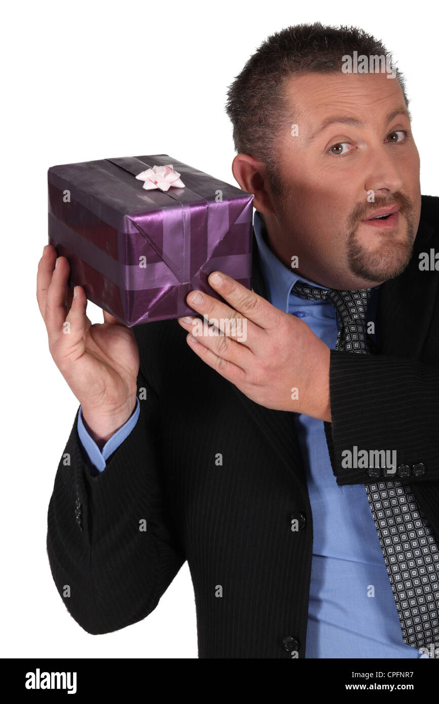 Man holding mysterious gift Stock Photo - Alamy