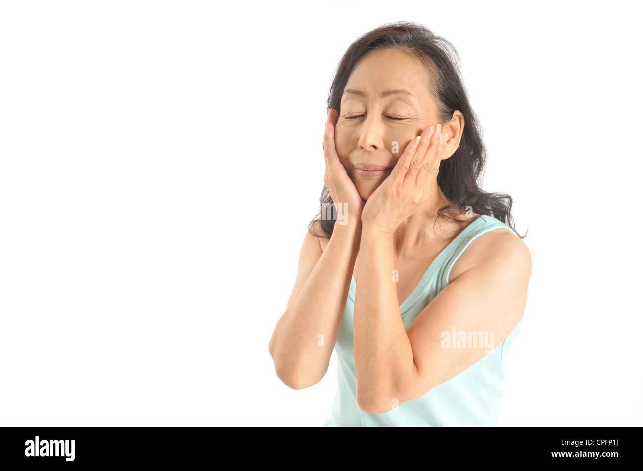 Woman smiling eyes closed hands Cut Out Stock Images & Pictures - Alamy