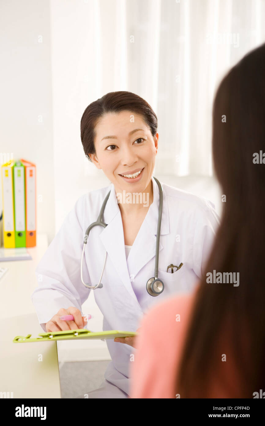 Female doctor talking to patient Stock Photo - Alamy