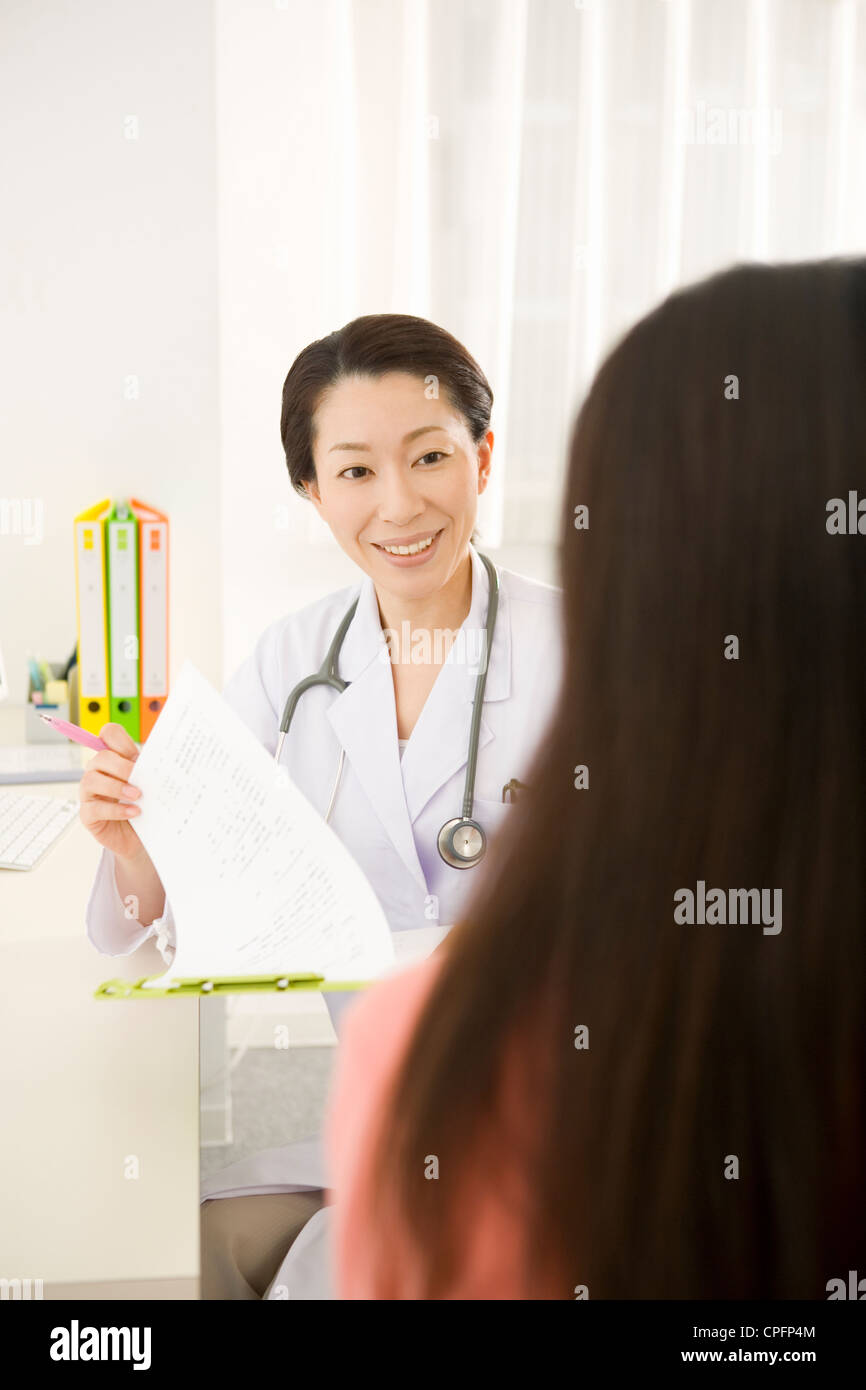 Female doctor talking to patient Stock Photo - Alamy