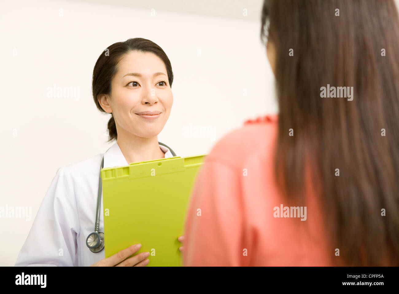 Female doctor looking patient Stock Photo - Alamy