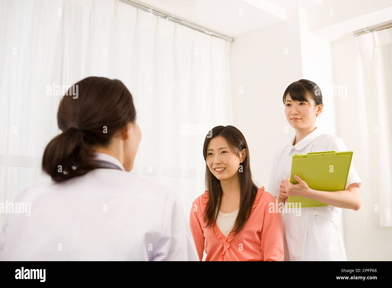 Female doctor talking to patient Stock Photo - Alamy