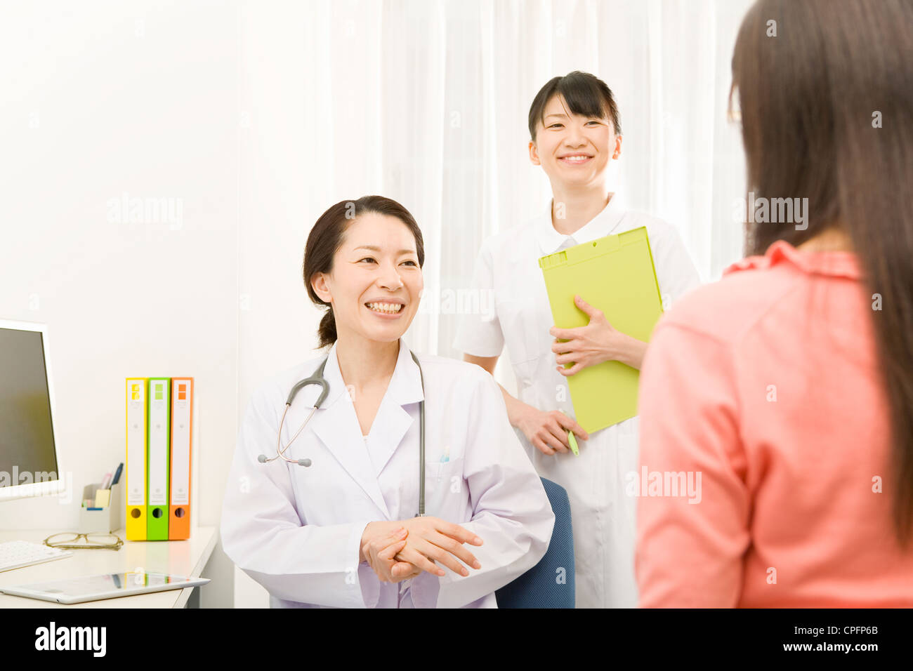 Female doctor talking to patient Stock Photo - Alamy
