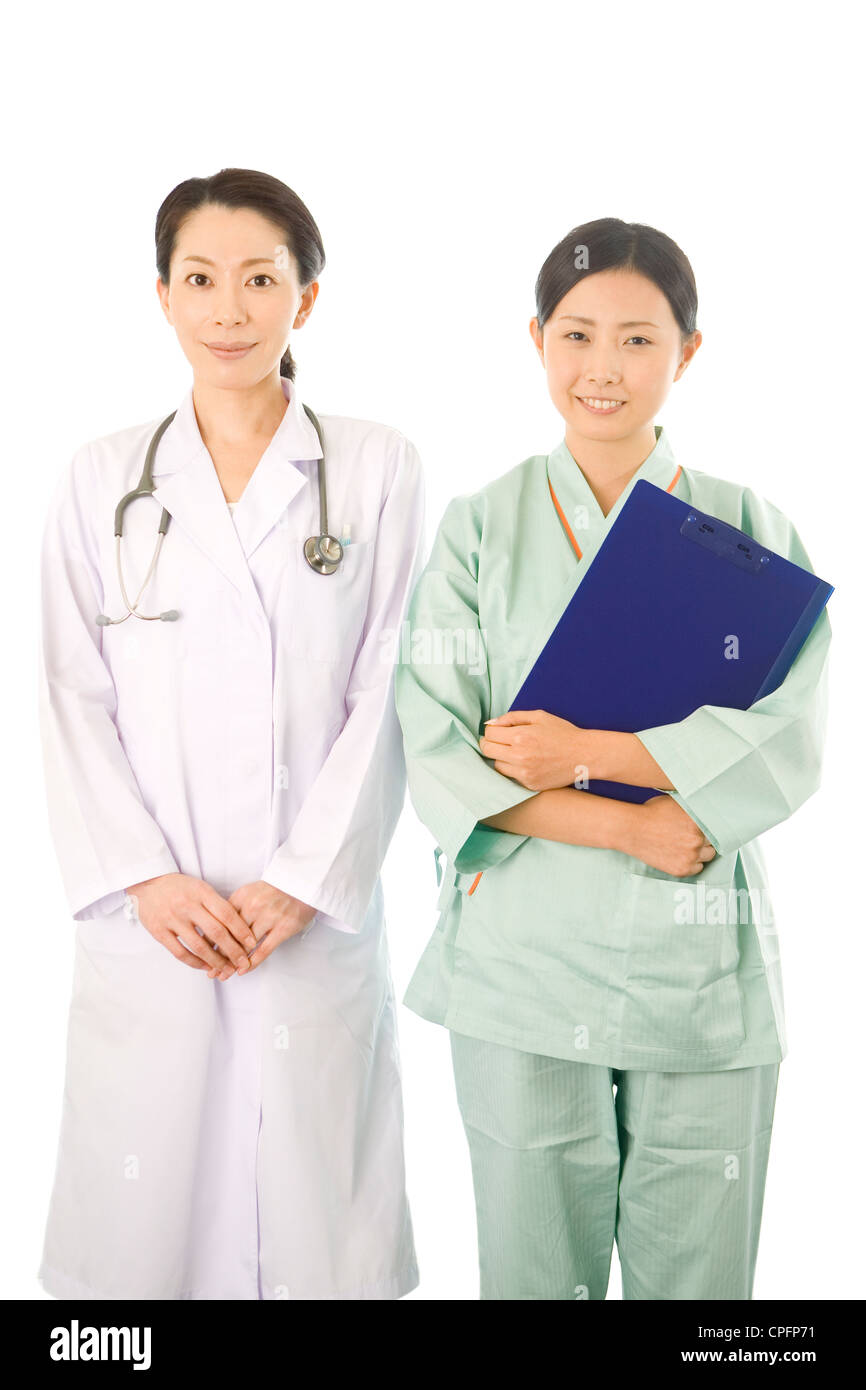 Female doctor and young woman in examination gown Stock Photo - Alamy