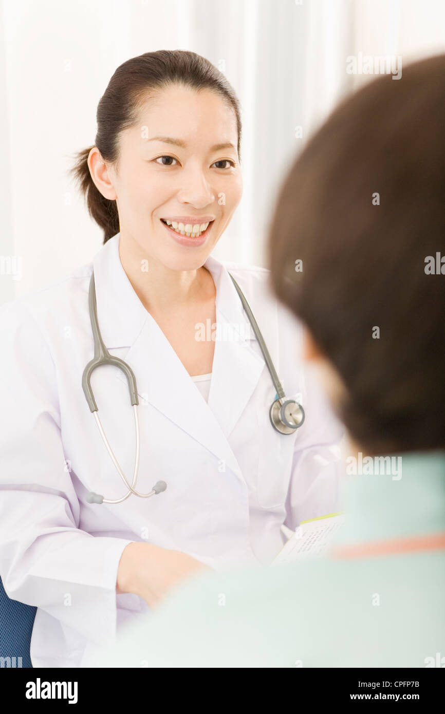 Female doctor talking to patient Stock Photo - Alamy