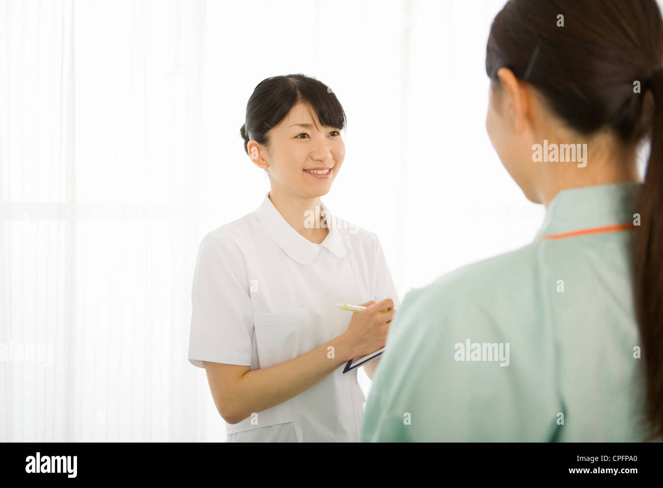 Female nurse talking to patient Stock Photo - Alamy