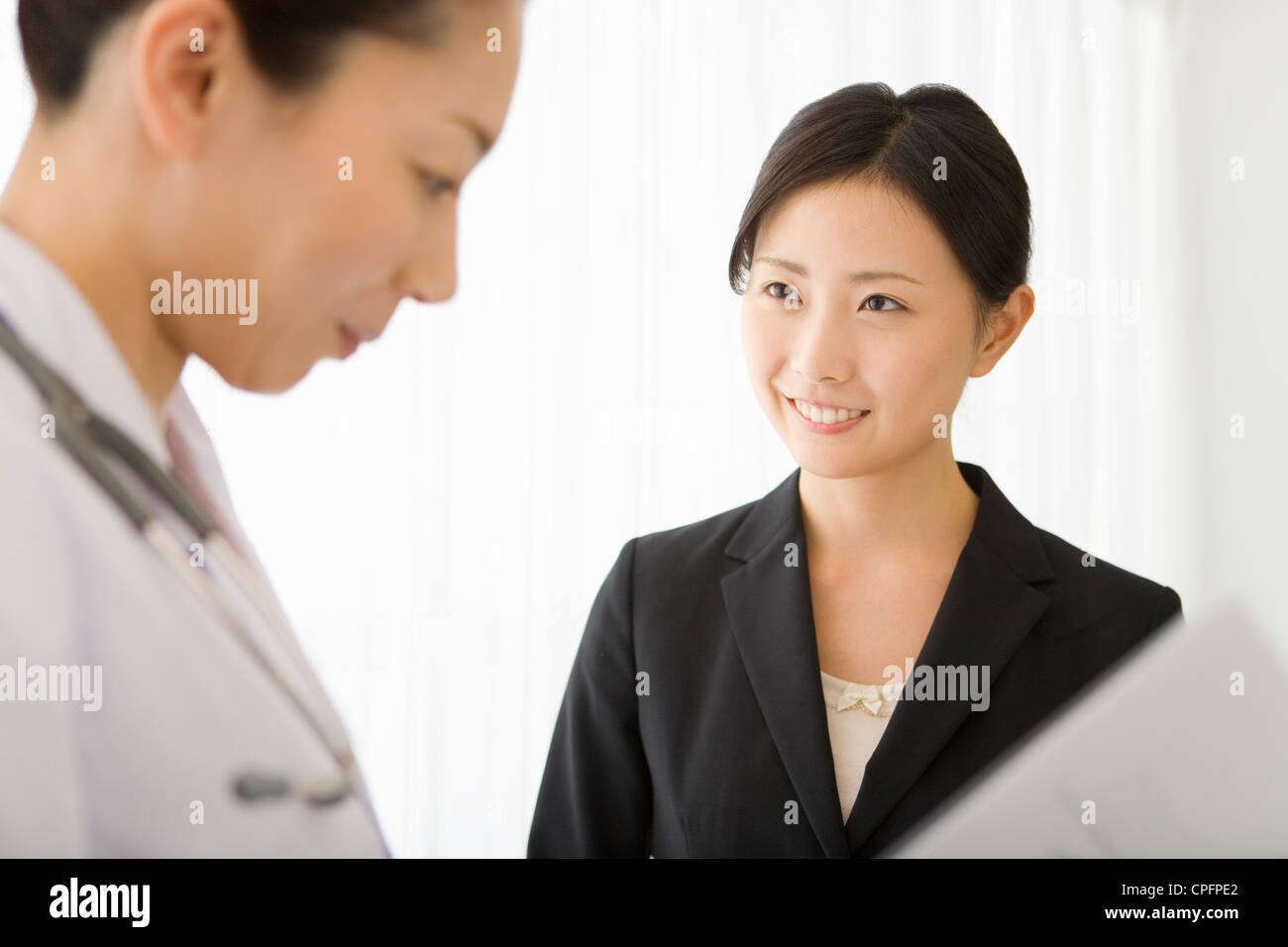 Pharmaceutical sales representative talking to female doctor Stock ...