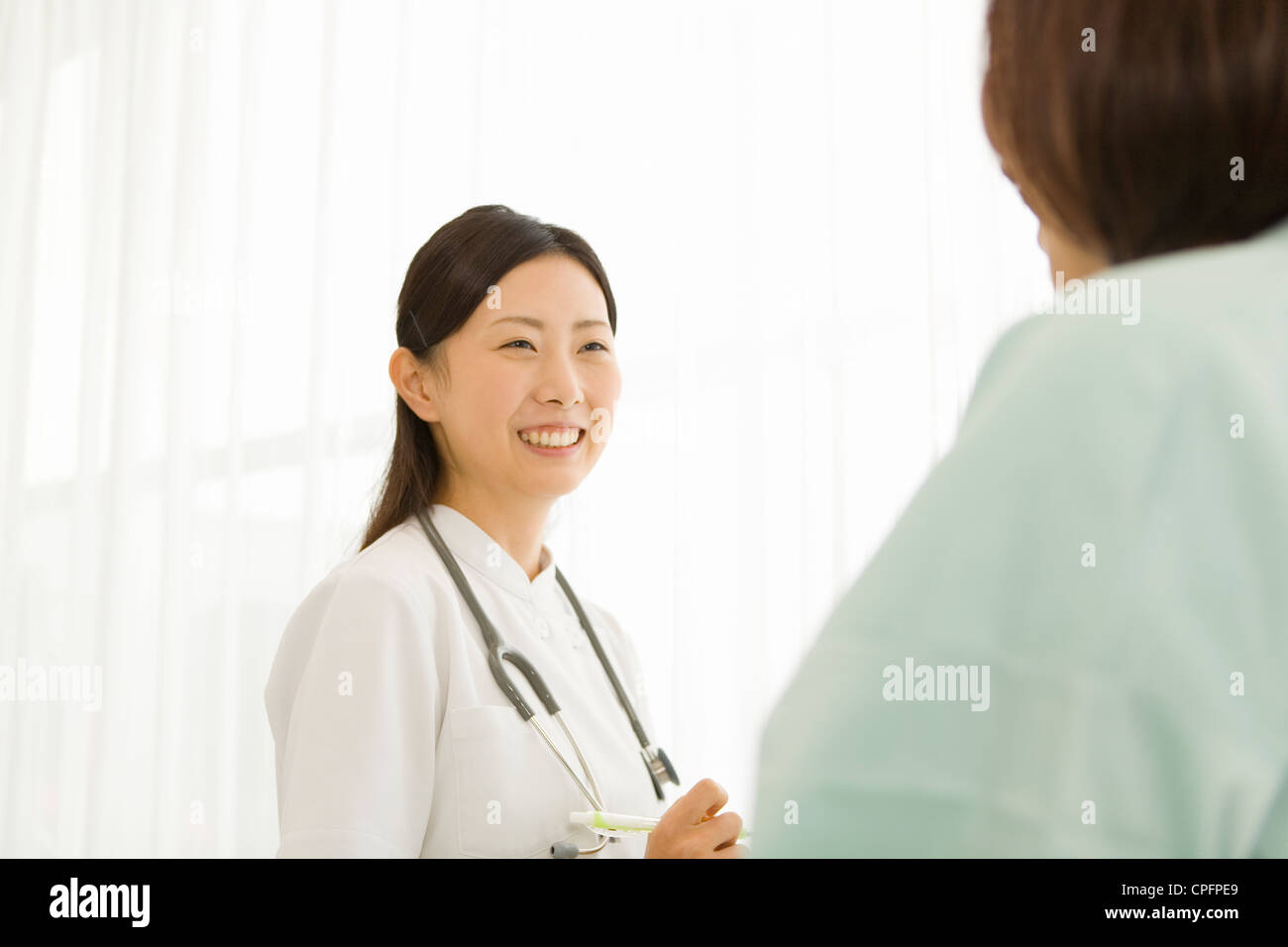 Female doctor talking to patient Stock Photo - Alamy