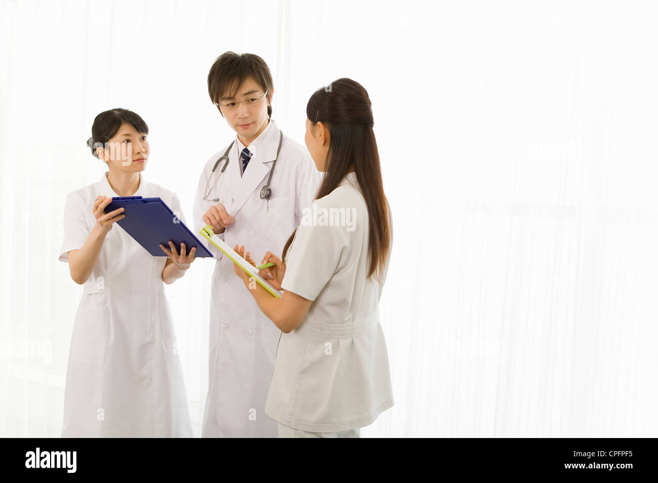 Doctor and female nurse having a meeting Stock Photo - Alamy