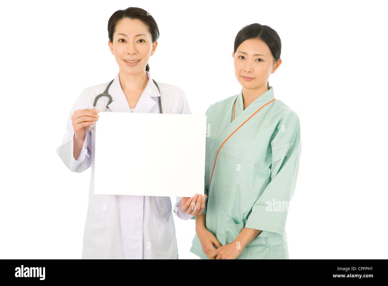 Female doctor and young woman in examination gown showing board Stock ...