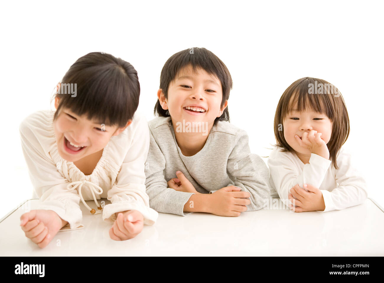 Three kids laughing Stock Photo - Alamy