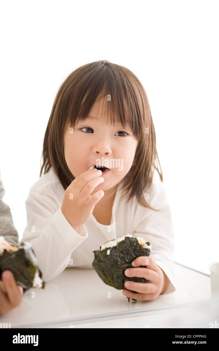 Boy eating rice ball Stock Photo - Alamy