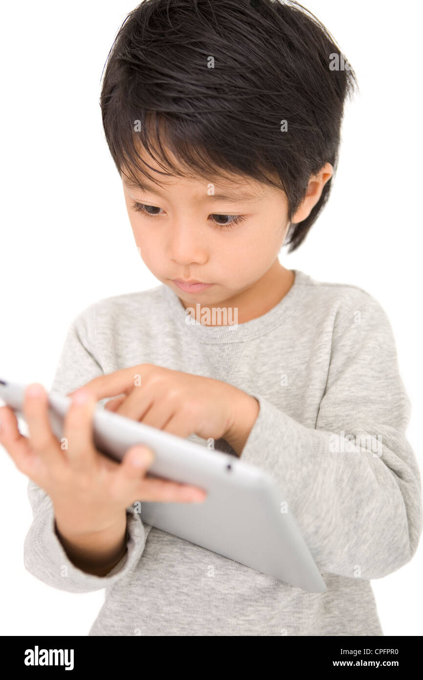 Boy touching tablet computer Stock Photo - Alamy