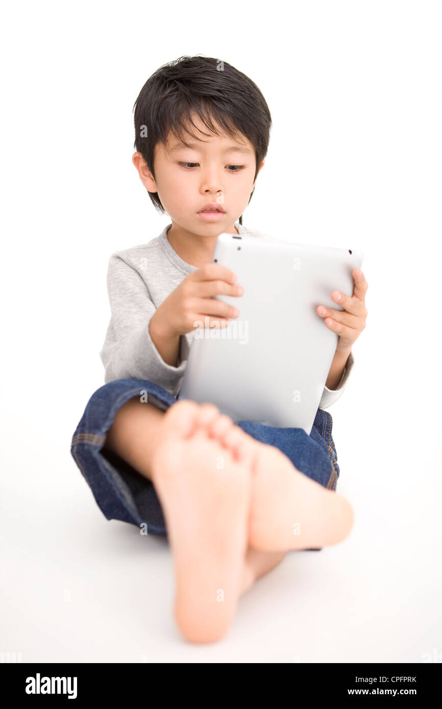 Boy looking at tablet computer Stock Photo - Alamy