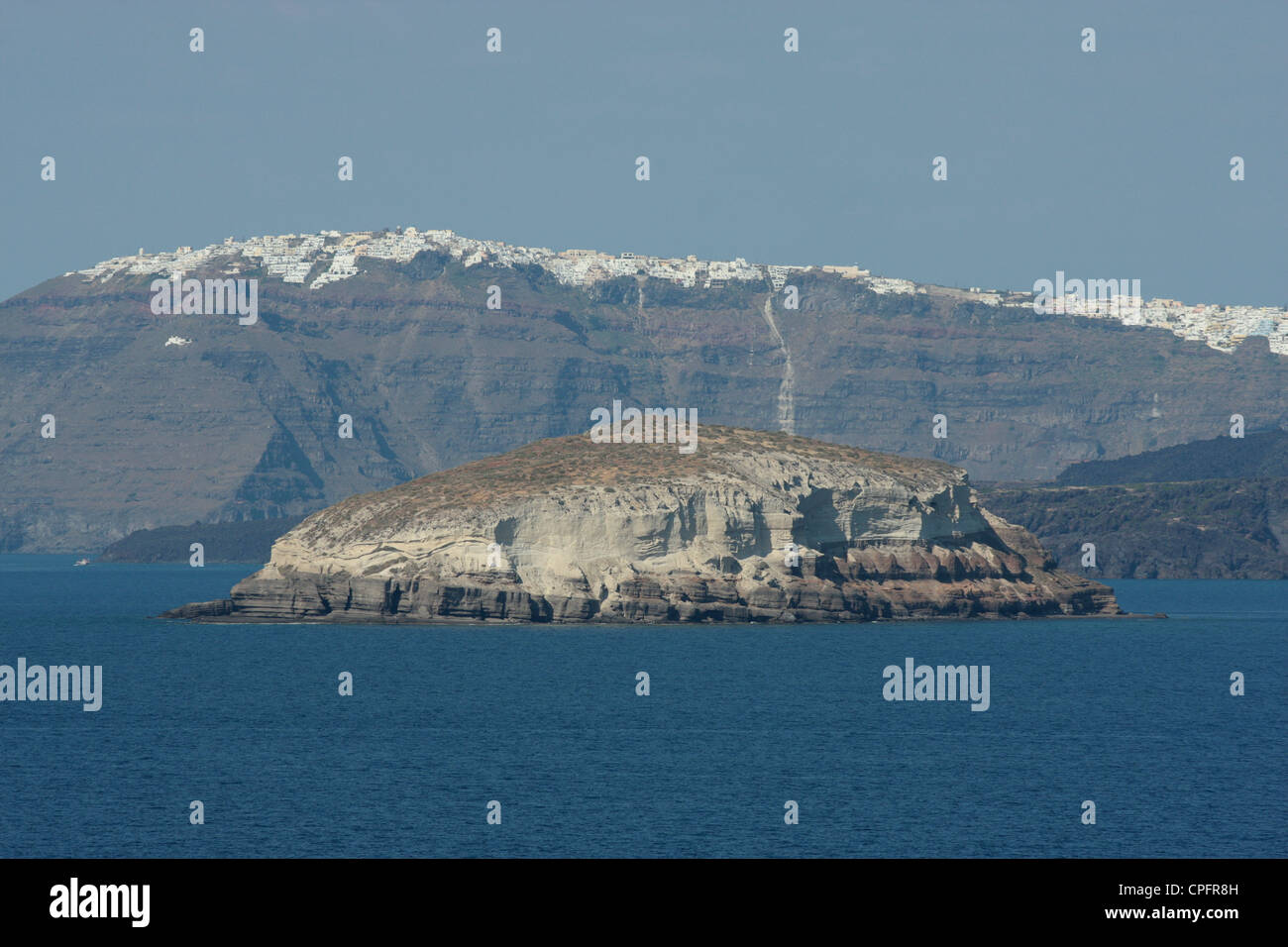 Nisida Strogilo islet at Santorini with Thira in the distance Stock ...
