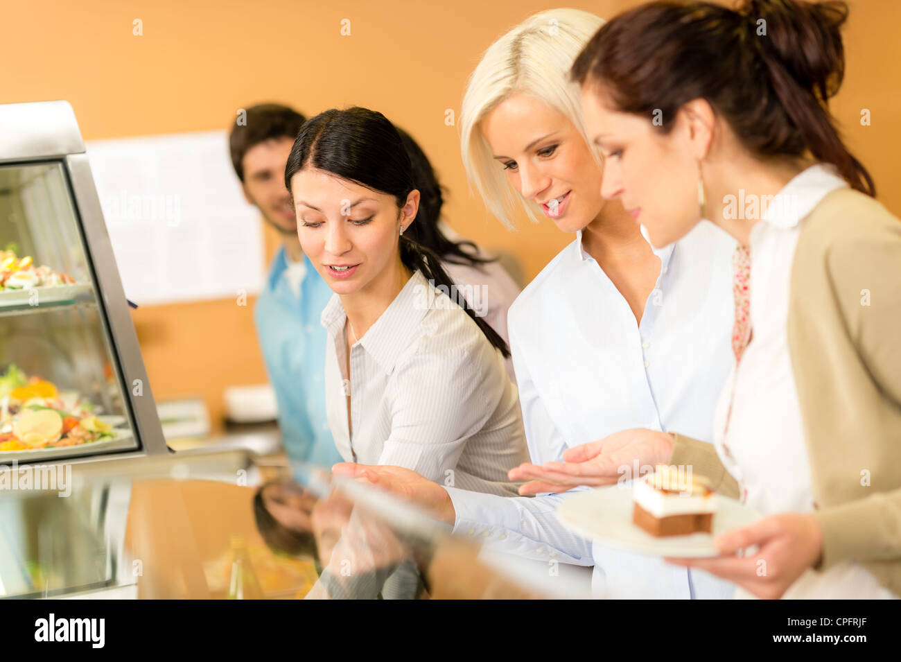 Cafeteria food young woman look dessert selection at office canteen ...