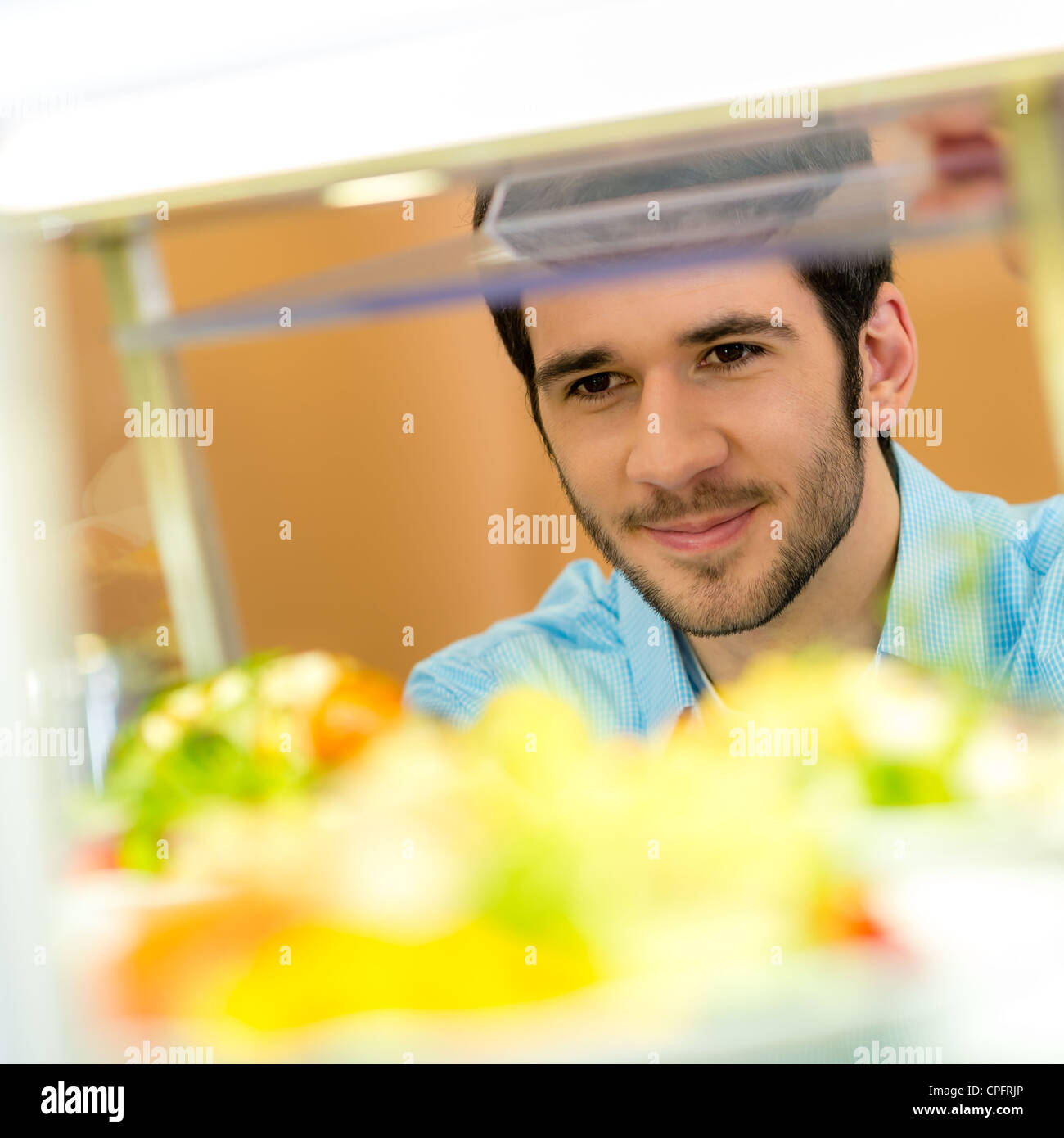 Cafeteria food display cabinet young man choose salad healthy lifestyle ...
