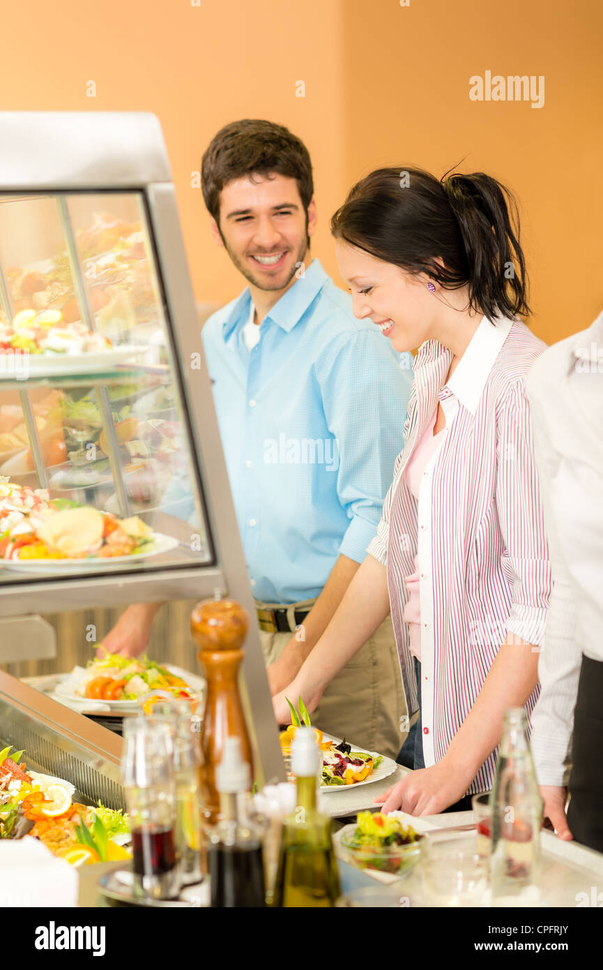 Cafeteria lunch young office colleagues choose salad self-service ...