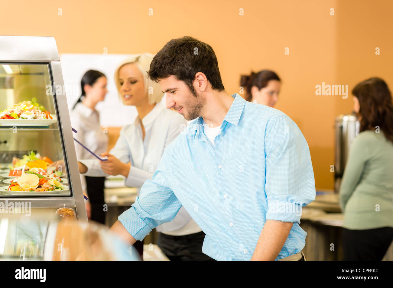 Business man take cafeteria lunch food from display cabinet self ...