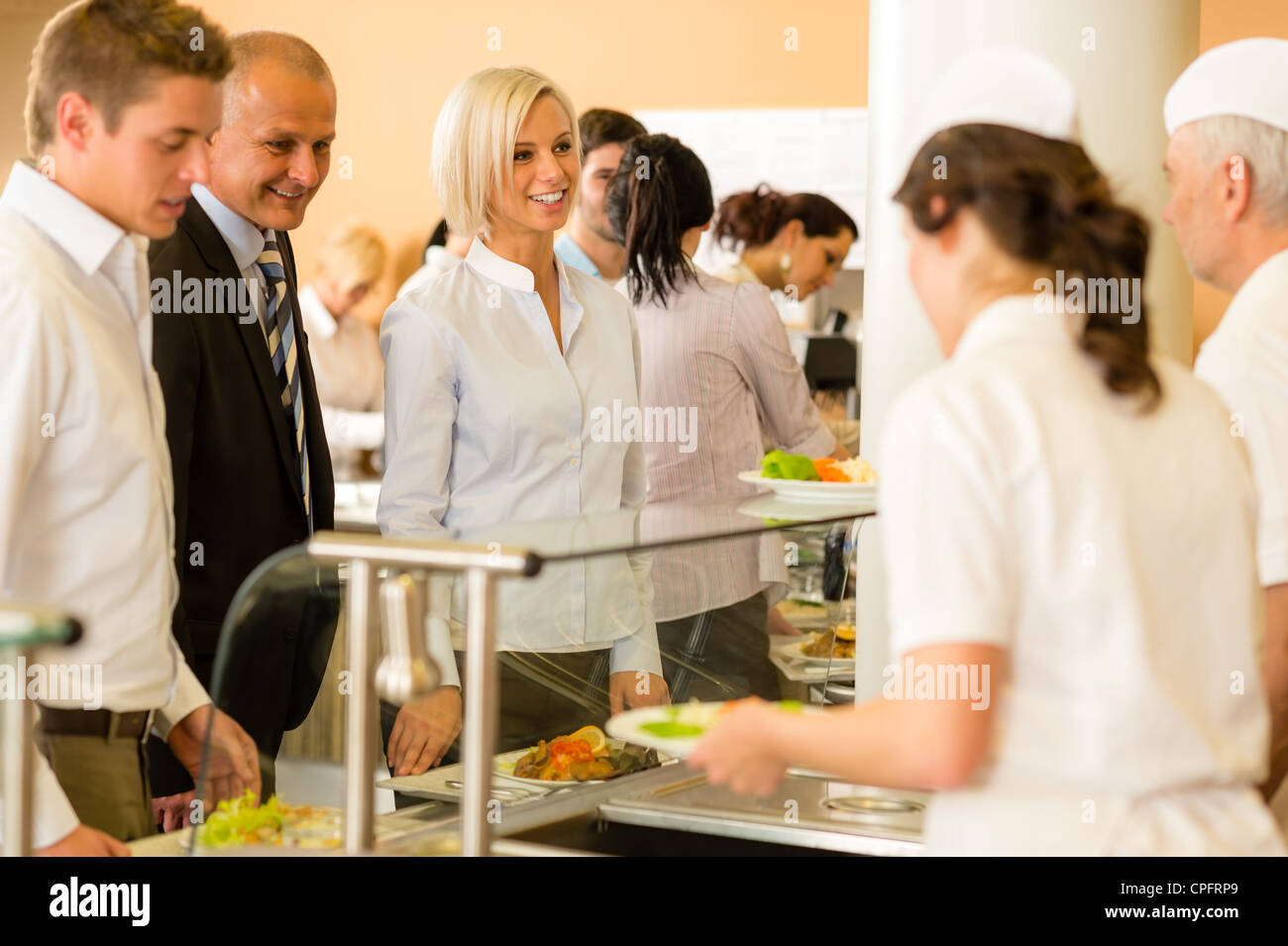 Cook serve meals business woman take lunch in cafeteria Stock Photo - Alamy