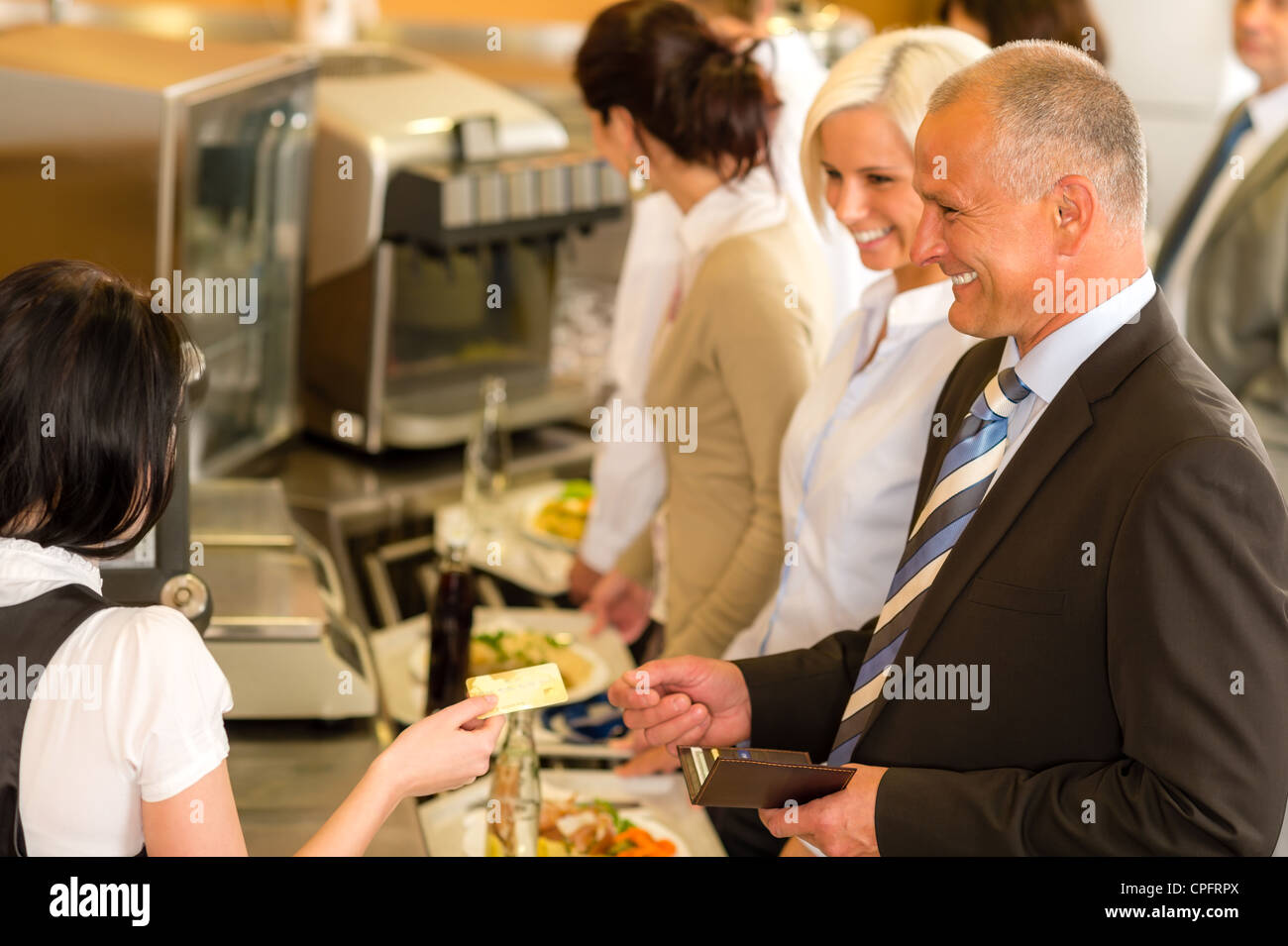 Cafeteria man pay by credit card cashier food on serving tray Stock ...