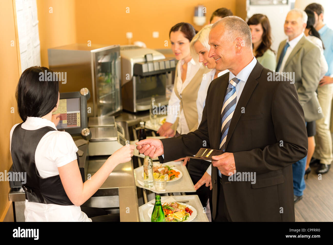 Cafeteria man pay by credit card cashier food on serving tray Stock ...