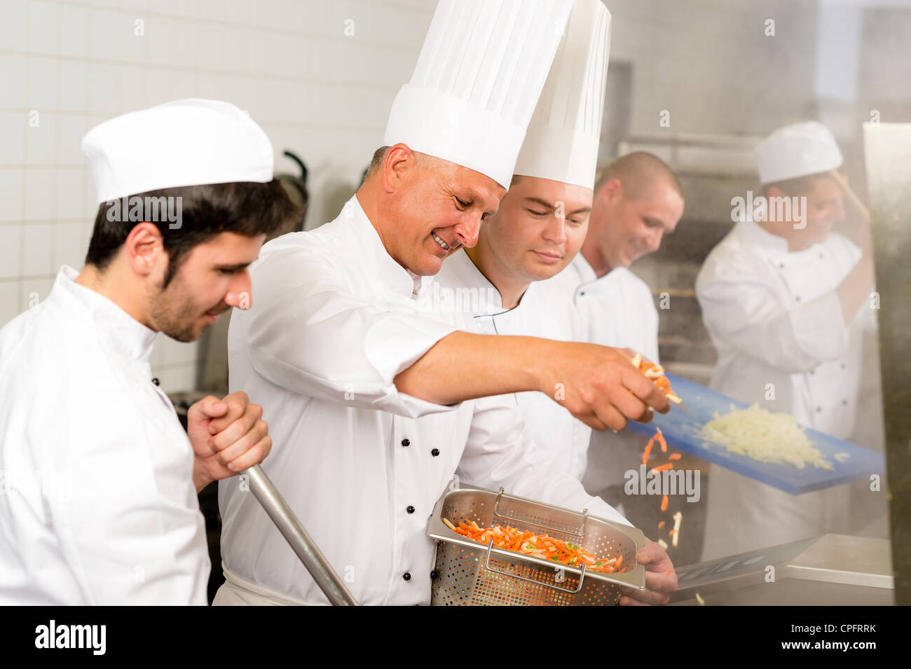 Professional kitchen happy chef prepare food meal international cuisine ...