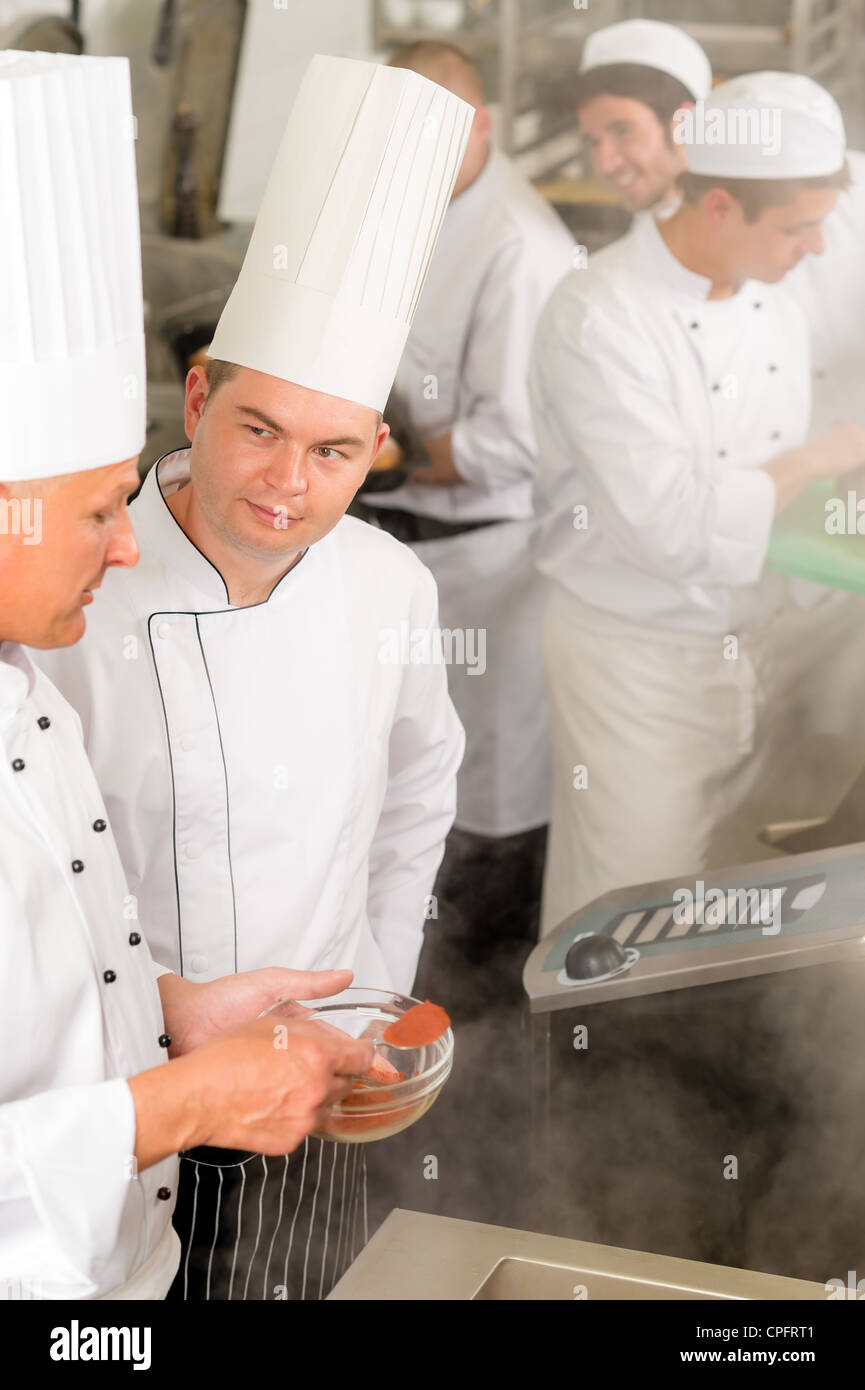 Professional kitchen chef cook add spice paprika prepare food meals ...