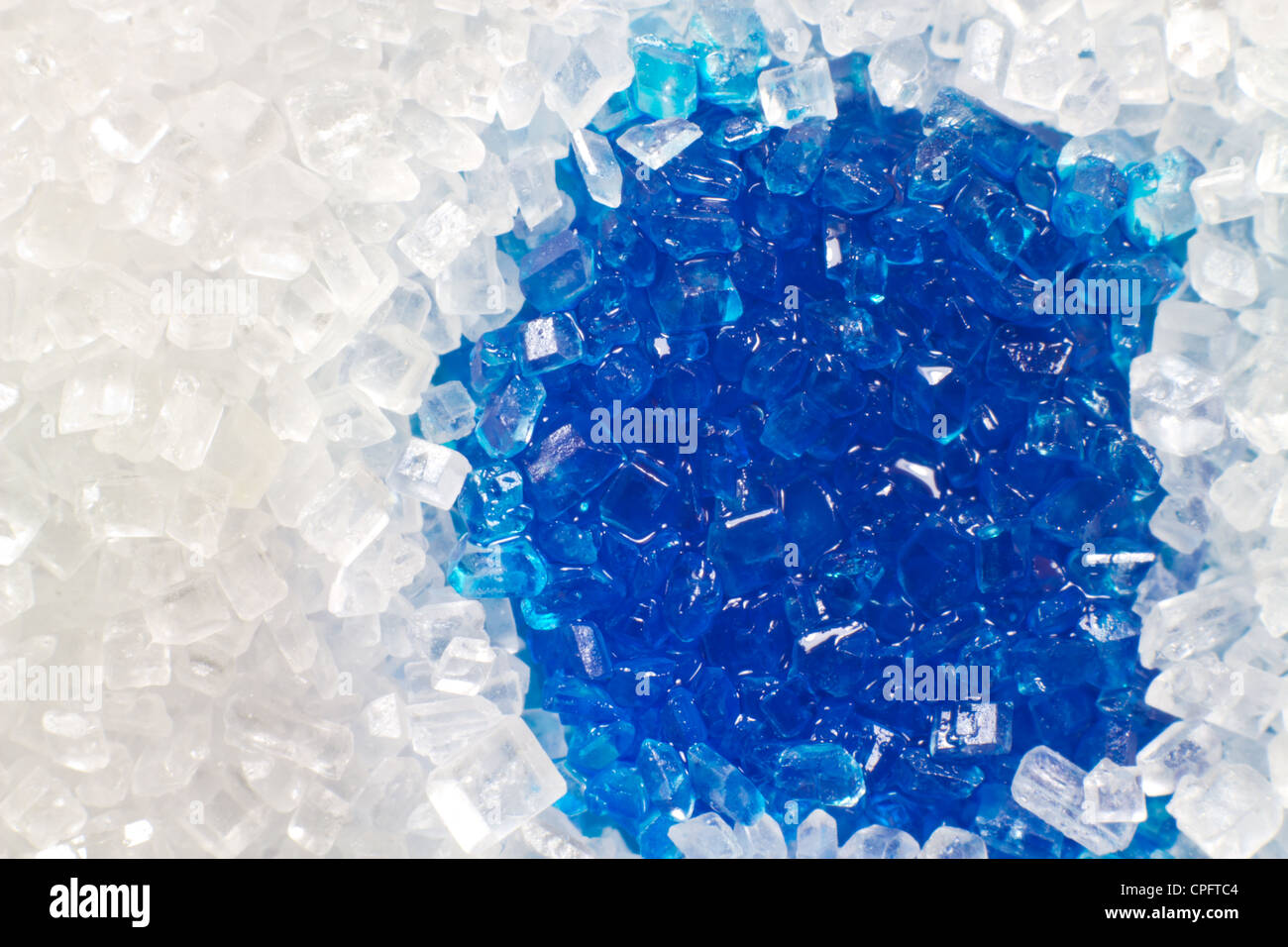 A macro picture of white sugar with blue liquid Stock Photo - Alamy