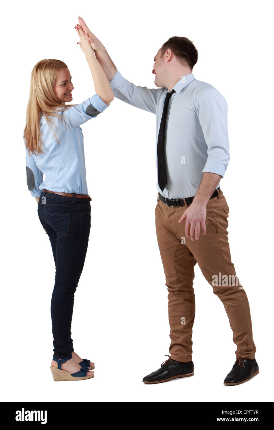 Happy young couple celebrating their success giving each other a high ...