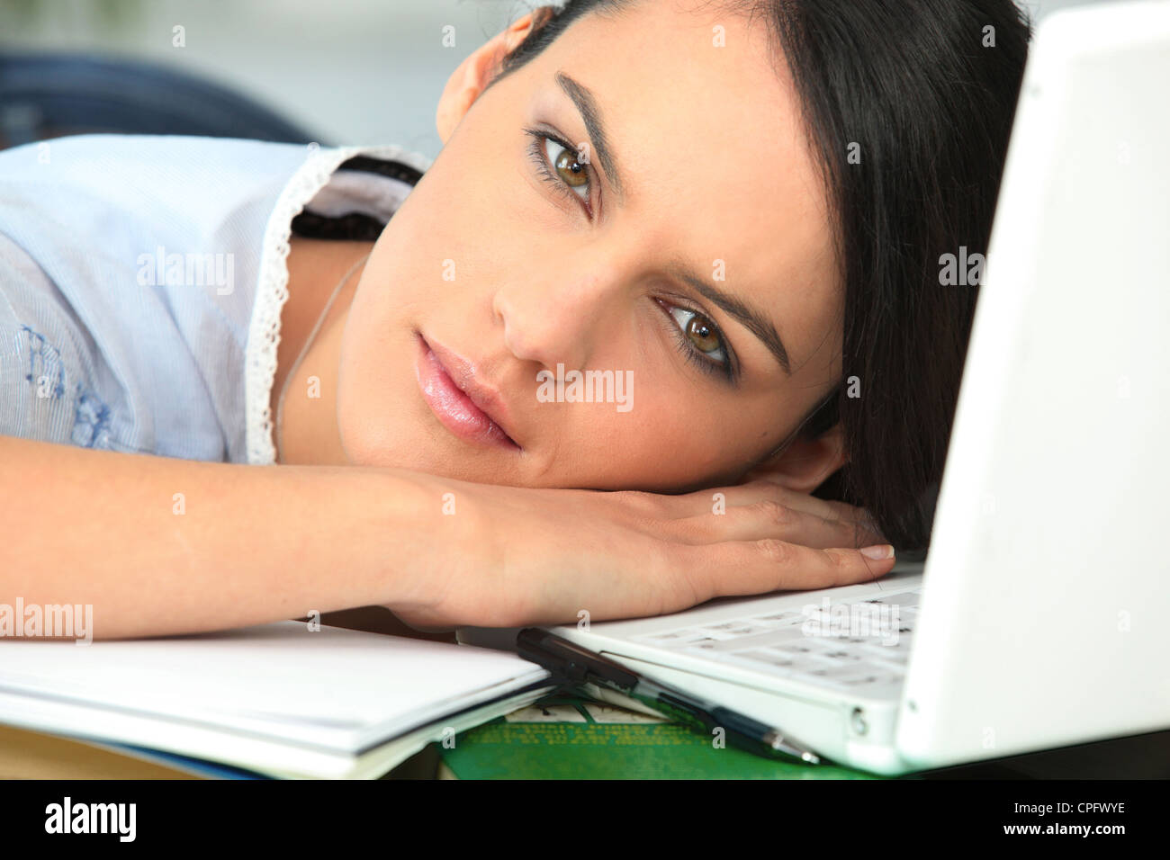 Girl falling asleep next to laptop computer Stock Photo - Alamy