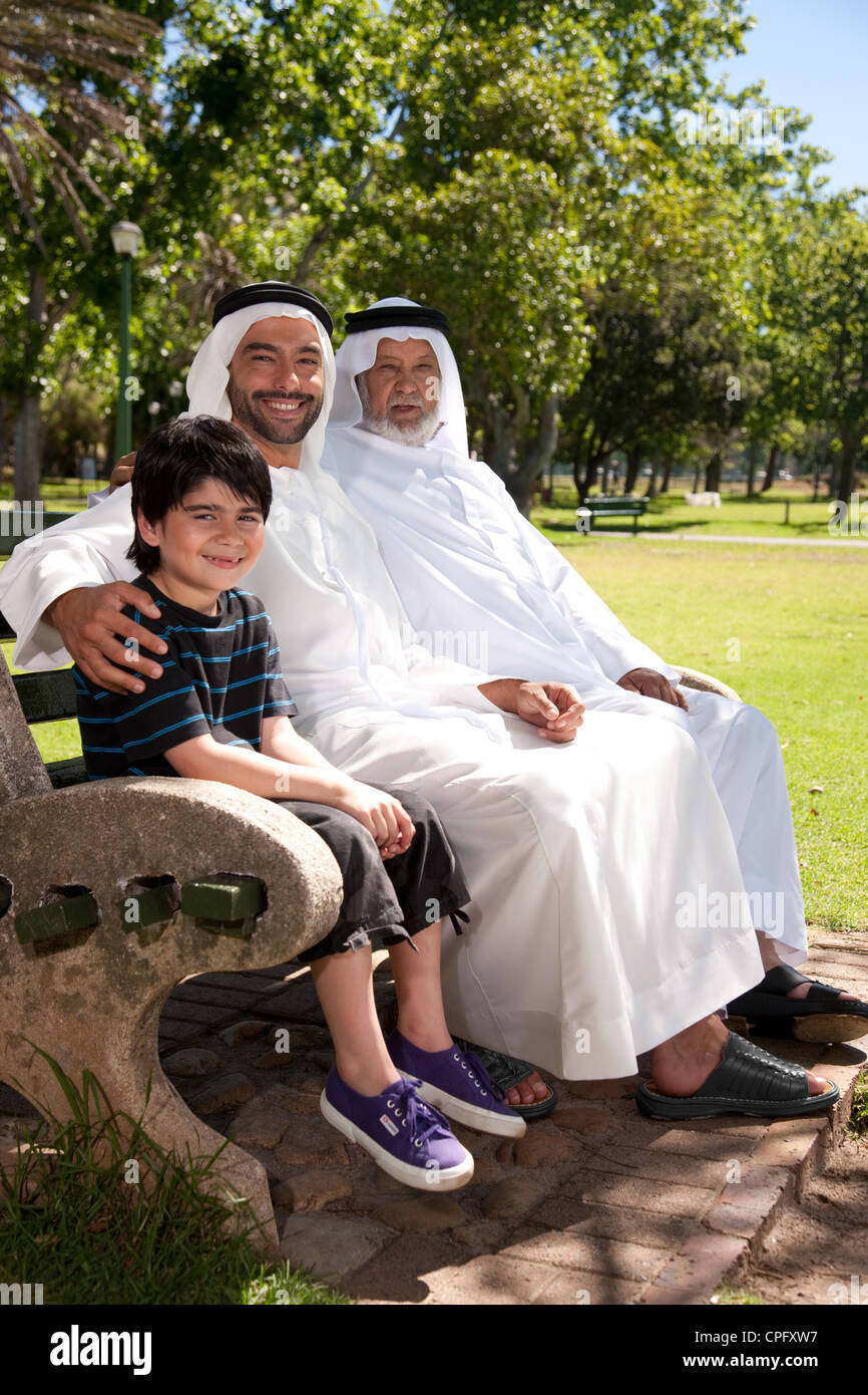Portrait of male multi-generation arab family sitting on bench at the ...