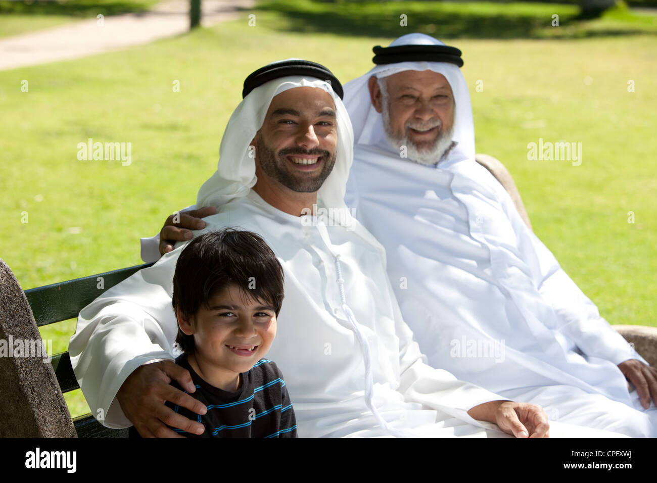 Portrait of male multi-generation arab family sitting on bench at the ...