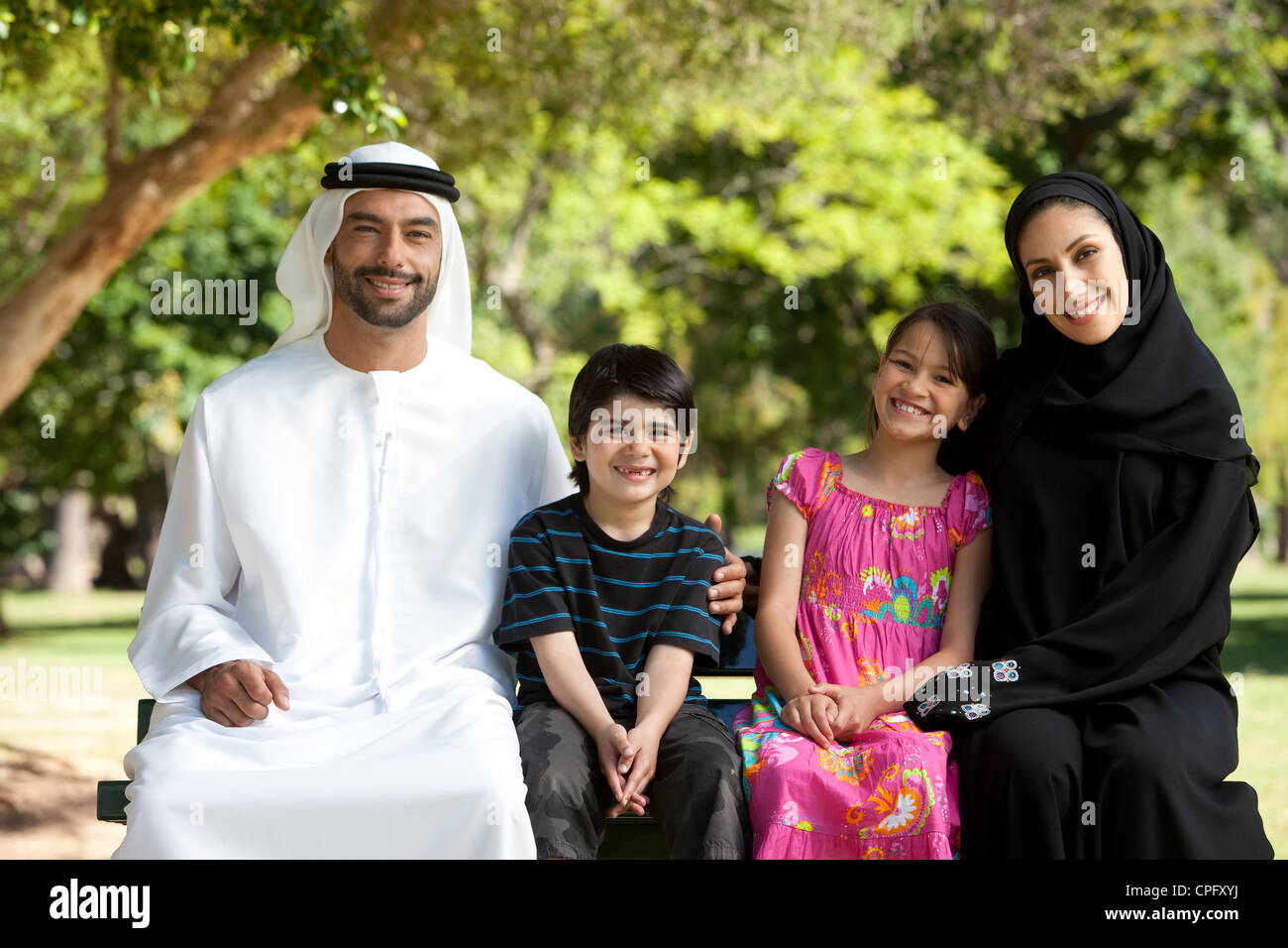 Portrait of an arab family sitting together at the park, smiling Stock ...
