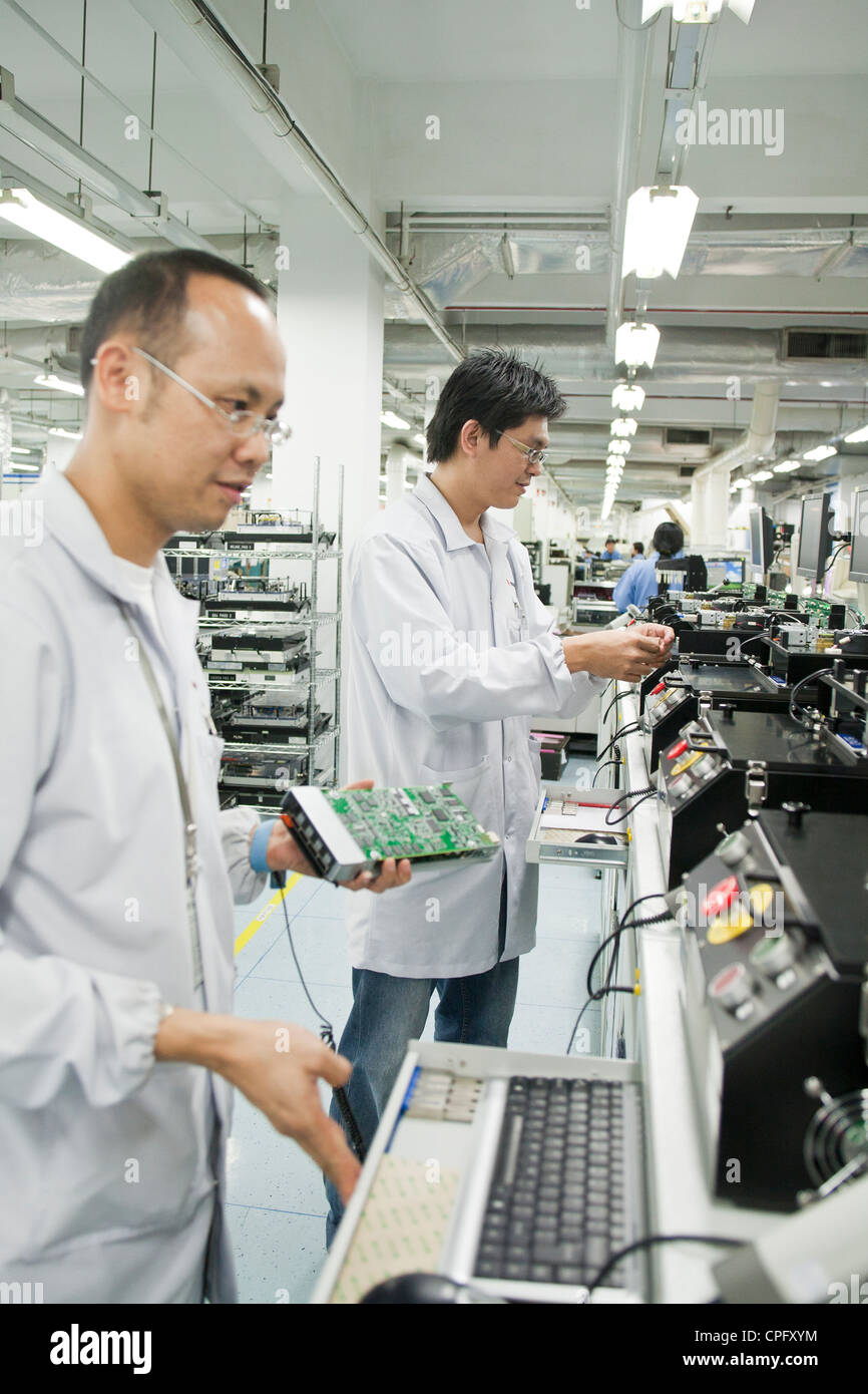 Workers assemble hand-held inventory computer devices on the assembly ...