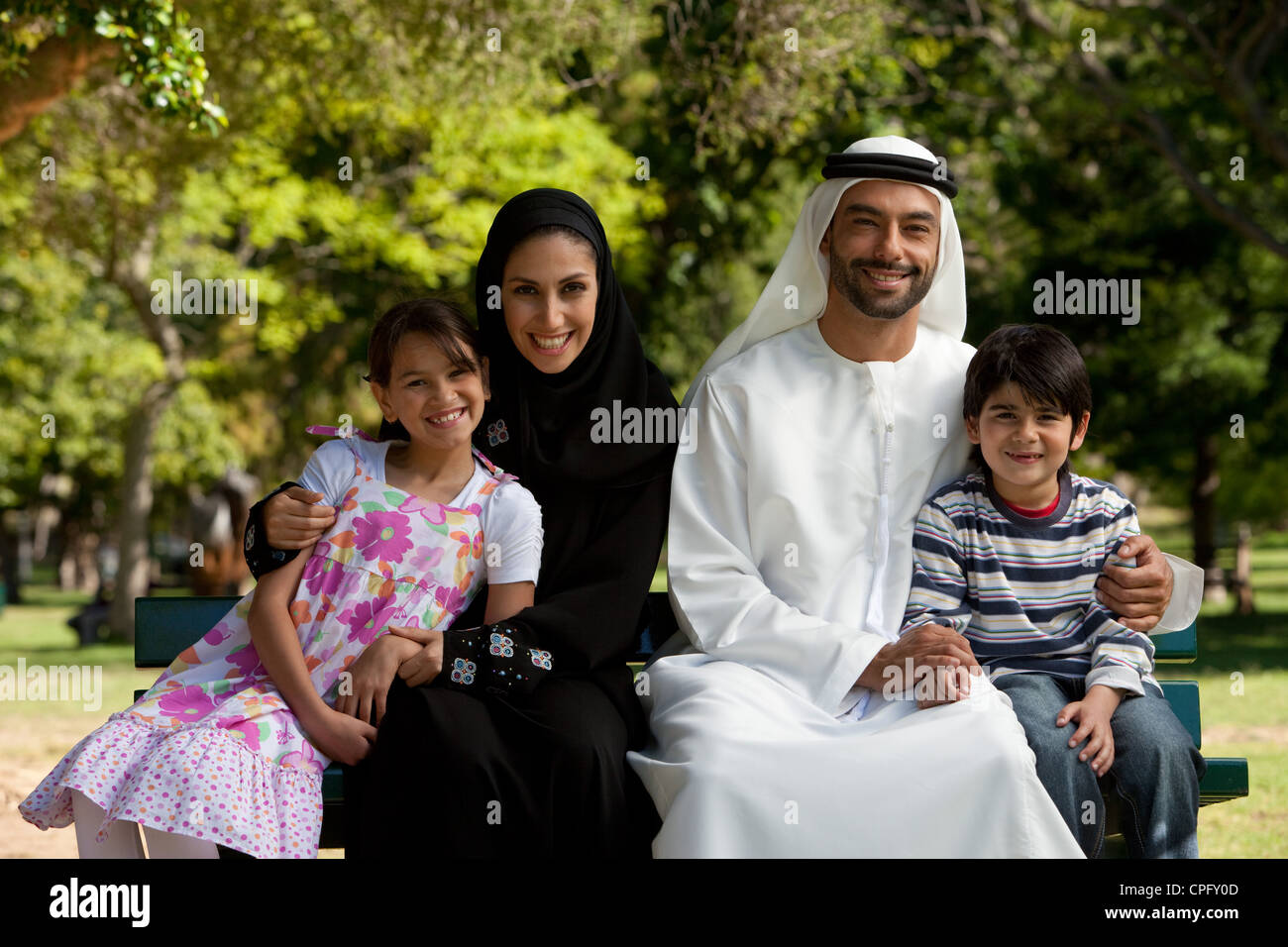 Portrait of an arab family sitting together at the park, smiling Stock ...