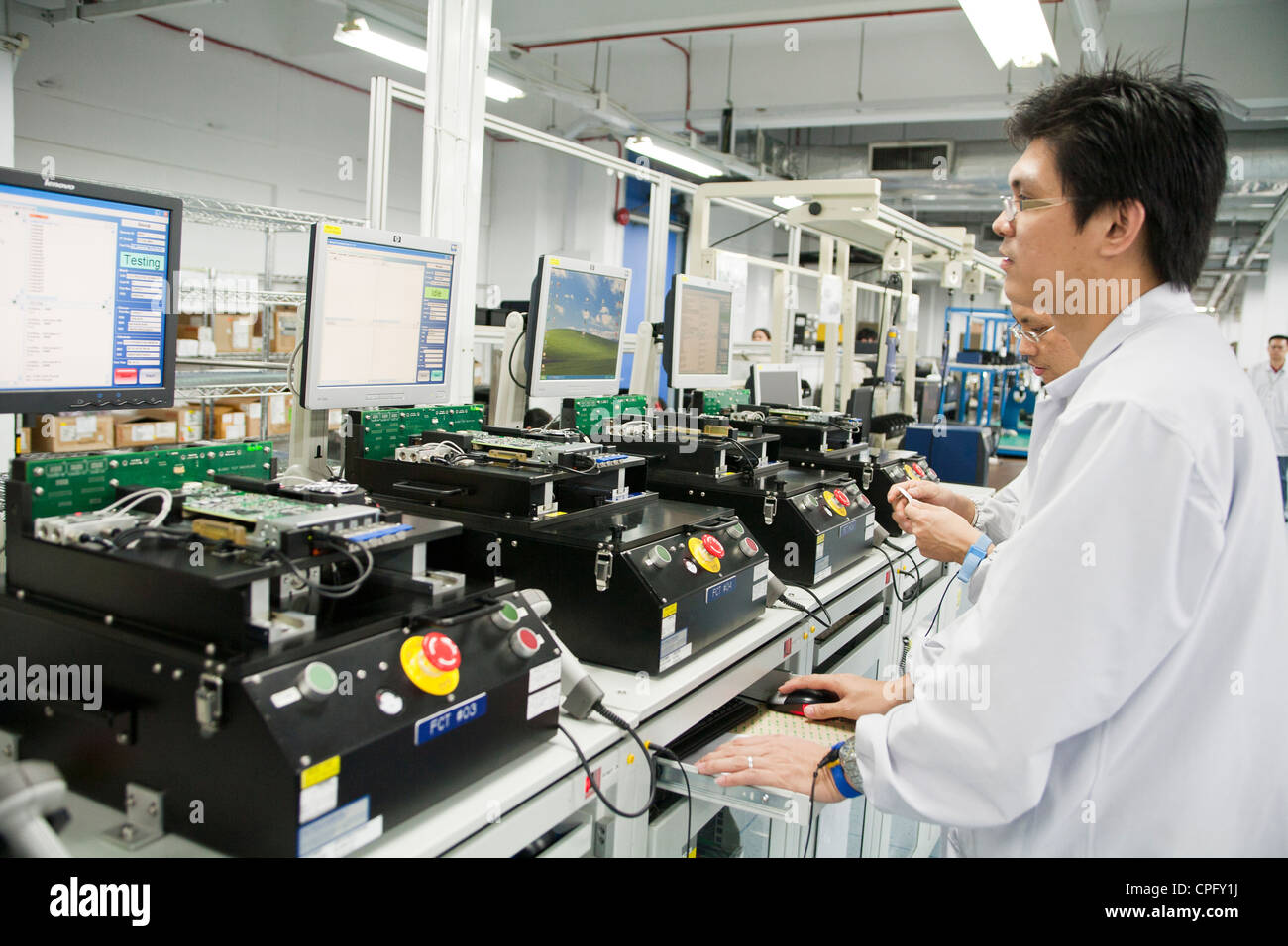 Workers assemble hand-held inventory computer devices on the assembly ...