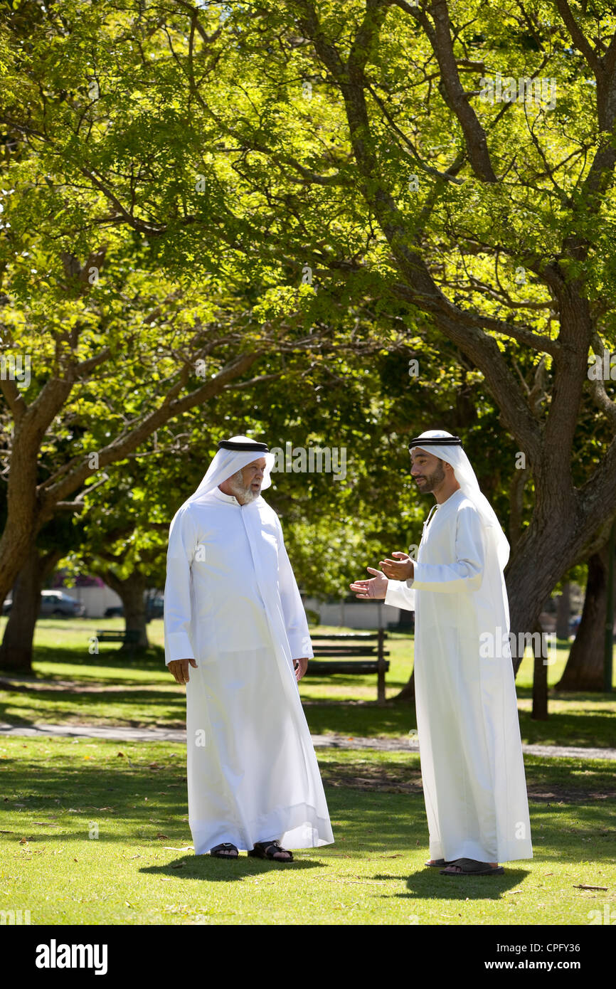 Arab father and son having discussion at the park Stock Photo - Alamy